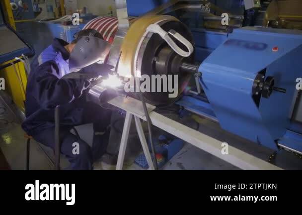 Arc welding workshop. Worker welding metal parts Stock Video Footage ...