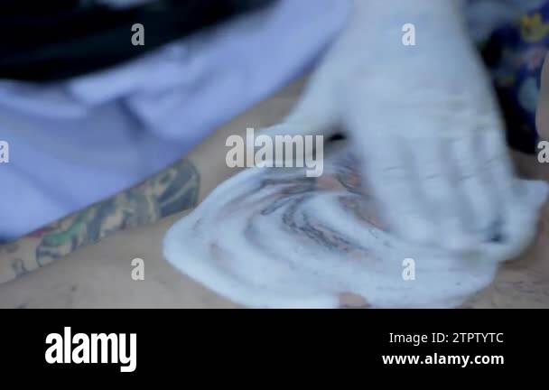 Tattooing concept of 4k Resolution. The tattoo artist is working in the ...