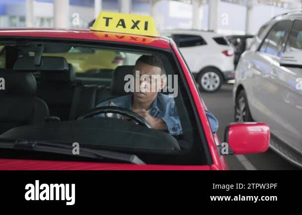 Upset African American taxi driver sitting in the car while counting ...