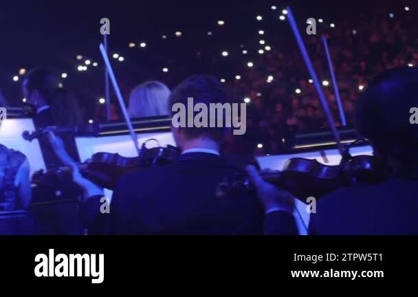 Musicians Violinists Are Playing With a Bows Blue Lights Music Books on ...