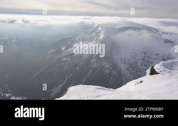 View of snow-capped mountain peaks. Clouds. Sunny day in the mountains ...