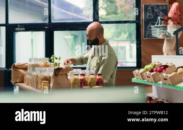 Smiling person looking to buy spices and grains from zero waste eco ...