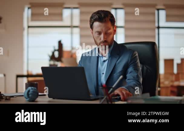 Focused businessman reacting cellphone at empty office. Serious man ...