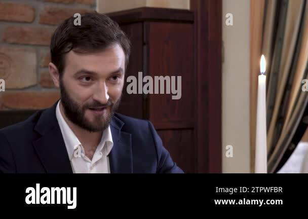 A bearded man in the suit is telling the story emotionally to the ...