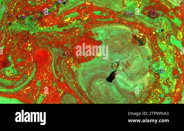 This stock video shows an oil paint mixture spreading out in slow ...