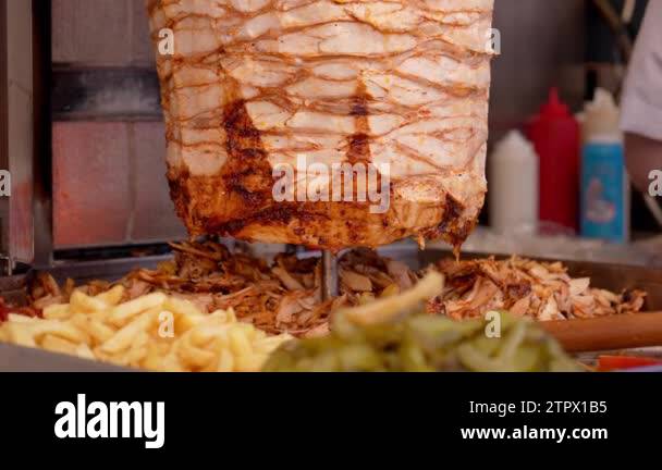 Meat on spit for Shawarma. Grilled meat. Cooking. Chef's Knife Cut ...