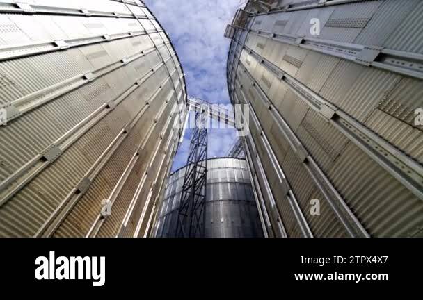 Granary grain elevators. Metal tanks for the storage crop. Large bins for farming. Aluminum ...