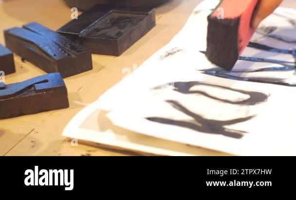Hand is Drawing a Letters With Sponge Black Paint Kids Are Drawing ...