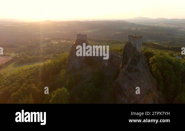 Trosky Castle aka Hrad Trosky aerial orbit sunset view. Famous landmark ...