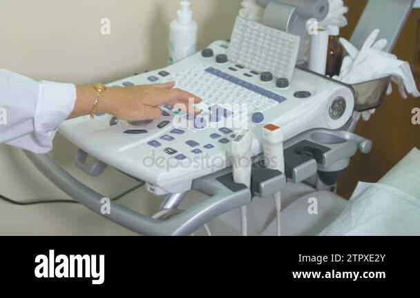 Ultrasound modern equipment. Female unrecognizable doctor operating ...