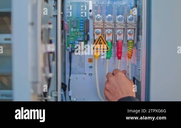 Electrician's hands testing current electrical. Engineer tests voltage ...