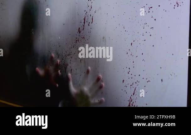 Blurred hands claw at blooded window, sign of deadly pandemic. Close-up ...