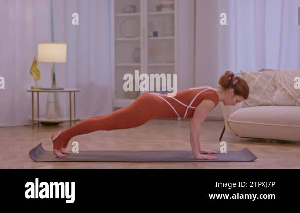 athletic girl shows the correct execution of movements, pilates workout ...