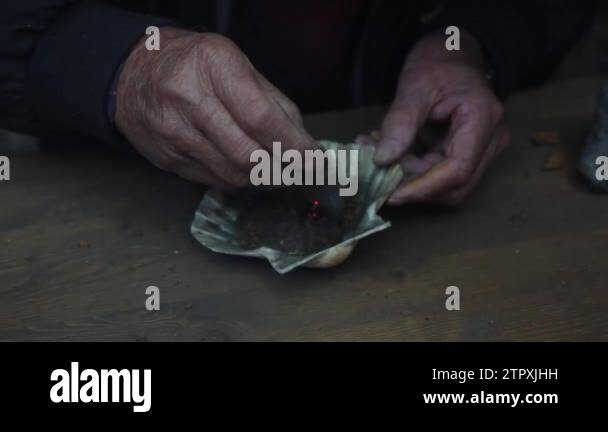 Experience ancient firecraft: skilled hands blend fungus powder in a ...