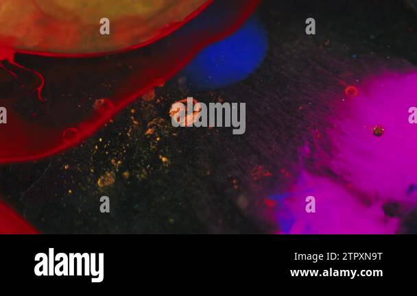 Ink water drop. Oil bubbles. Defocused red blue magenta pink color ...