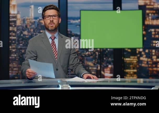 Breaking news reporter talking in front chroma key monitor tv studio ...