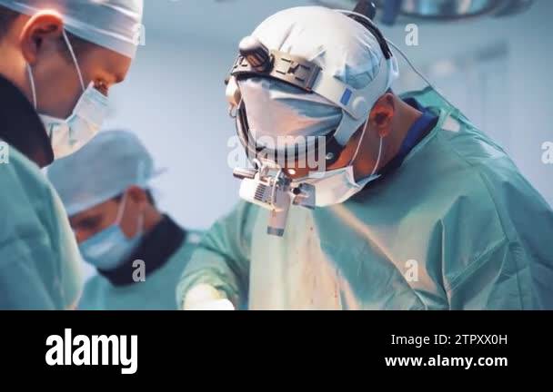 Medical team helping patient. Surgeon with his team performing surgery ...