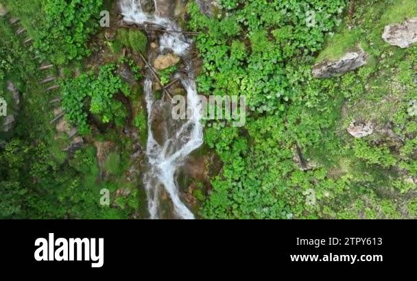 Beautiful waterfall in green forest, top view. One of the hidden gems ...