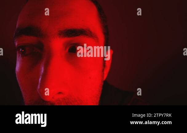 Man with shocked facial expression moves his eyes from side to side ...