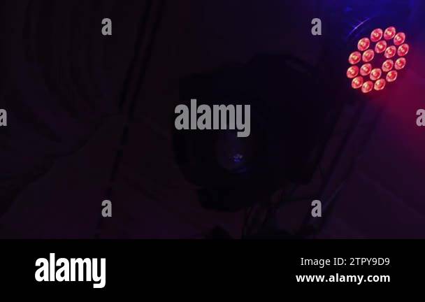 Stage lighting equipment. Spotlights turning and sparkling. Automated ...