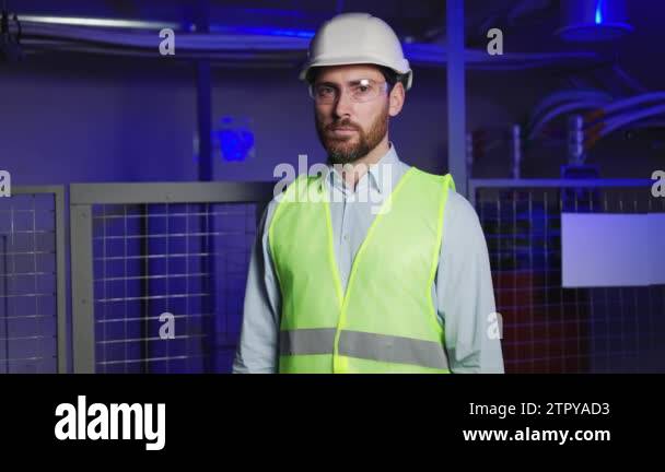 Confident male engineer technician standing in a technical room of ...