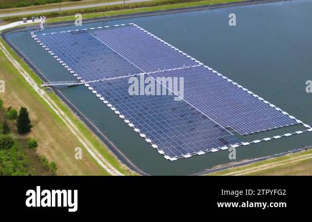 Industrial pond with floating photovoltaic solar panels for producing ...
