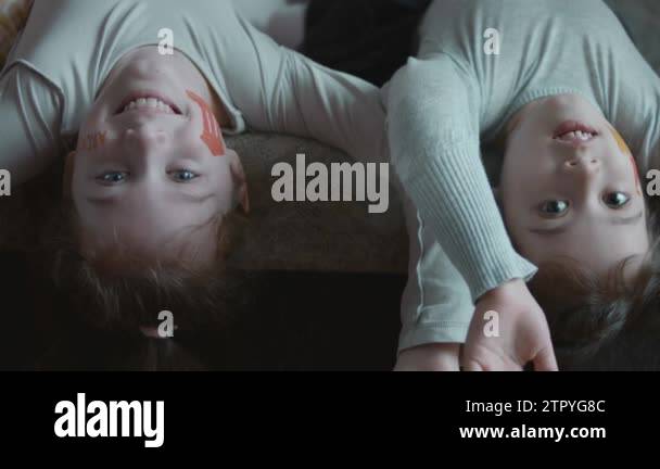 Two smiling cute little girls with drawings with the theme of ...