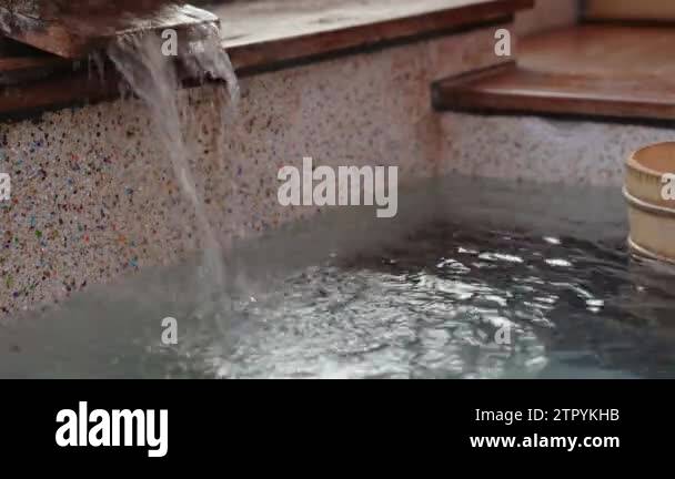 Japan natural mineral hot spring water flowing and wooden barrel ...