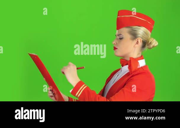 Girl writes a pen in a special folder, she is a flight attendant. Green ...