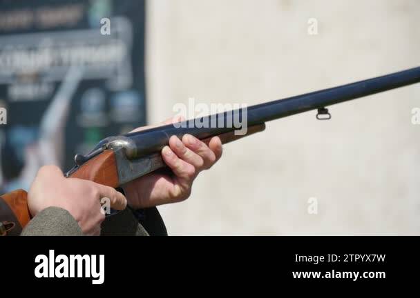 Rifleman turning his rifle and shooting on a range on a sunny day in ...