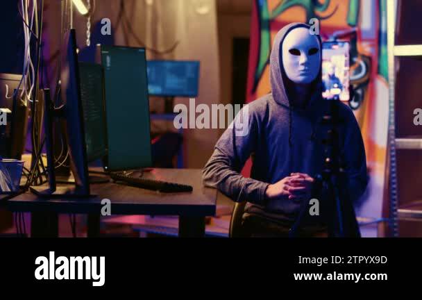 Dangerous hacker filming video threatening to launch cyber attack on ...