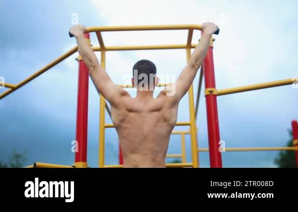 Strong man do street workout with difficult exercises and pose to ...
