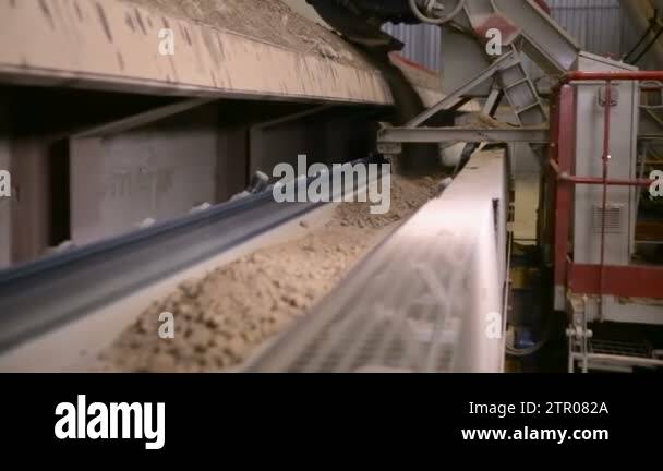 Conveyor with soil. Clay goes through transporter in a mining factory ...
