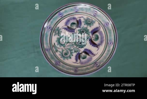 Rotation of a finished porcelain plate painted with patterns in the ...