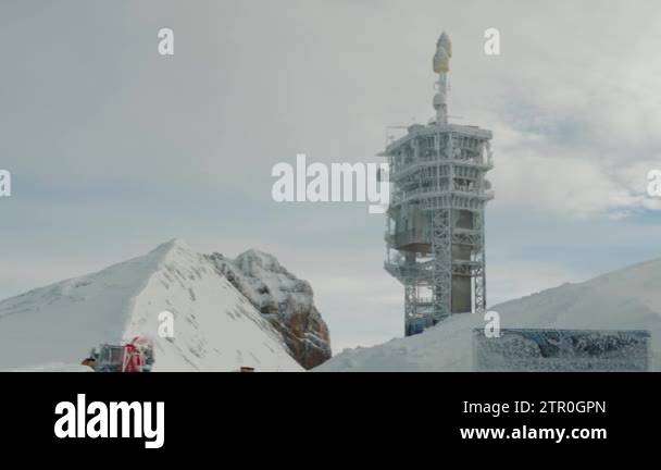 Mountain Titlis summit covered in snow with high meteo weather tower ...
