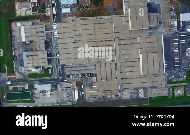 Manufacture on field. Industrial zone with car parking. Roofs of ...