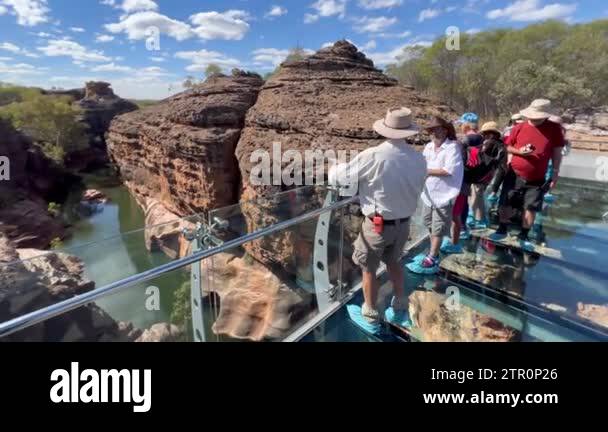 MOUNT SURPRISE, QLD - MAY 05 2023:Australian tourists crossing over a ...