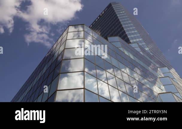 Time-lapse of glass skyscrapers with clouds and blue sky. clouds and ...