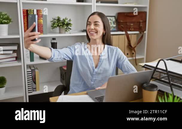 Radiant young hispanic woman captures selfie with smartphone during ...