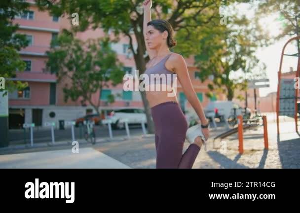 Confident athlete stretching arms enjoying physical workout. Serious mature woman training ...