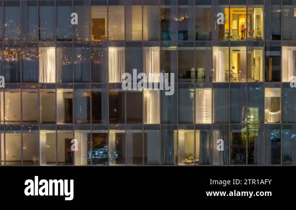 Windows of the multi-storey building of glass and steel lighting inside ...
