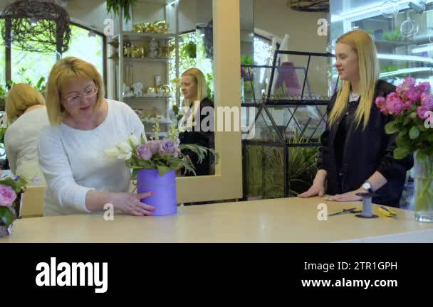 Client come to flower shop to take away complete flower composition ...