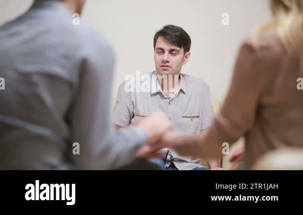 male psychologist helping worried young couple. family therapy. angry ...