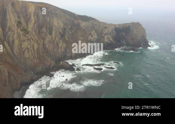 Ocean Waves Hit Cliffs During Fog Stock Video Footage - Alamy