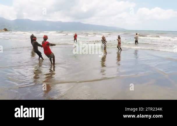 Native fishermen fishing on sea, using traditional technique pulling ...