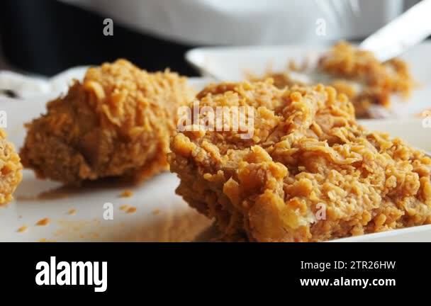 Eating Fried chicken in fast food restaurant, camera slide slow motion ...