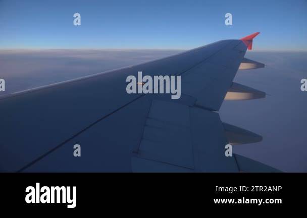 Jet Plane Wing With Blue Sky And Horizon Seen From The Window Of The ...