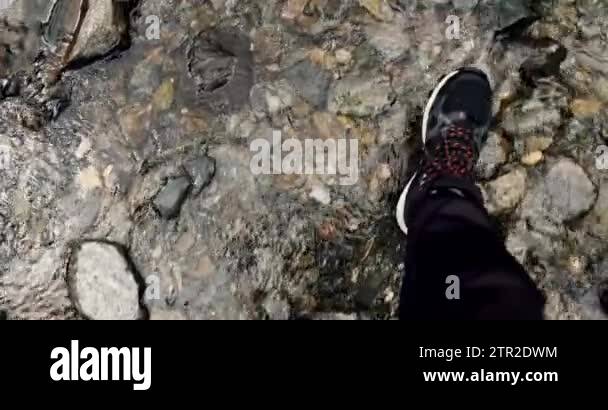 Top view on person feet in sport hiking boots walking and crossing ...