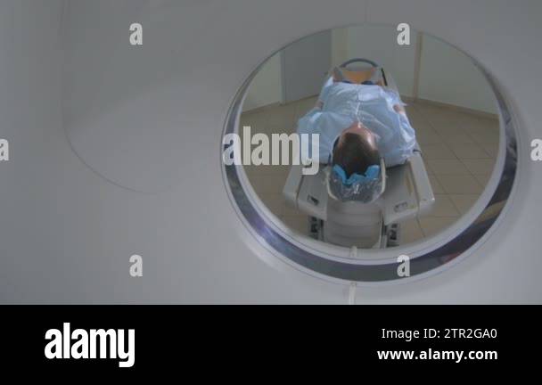 Patient in a Emergency hospital MRI scanner. Man lays in Magnetic ...