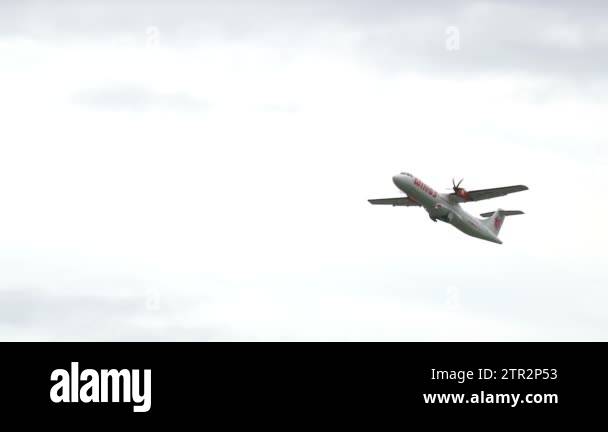 HD footage of a twin engine plane taking off in silhouette against a ...